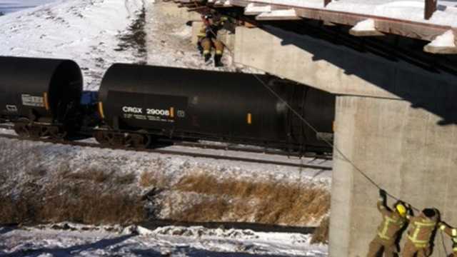UPDATED: Worker wedged under bridge after train hits boom lift
