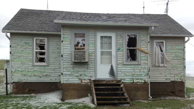 Hail pools around house after breaking windows