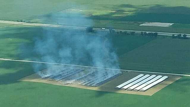 Massive bale fire continues to smolder 3 days later