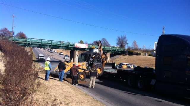 PHOTOS: Backhoe blocks highway traffic