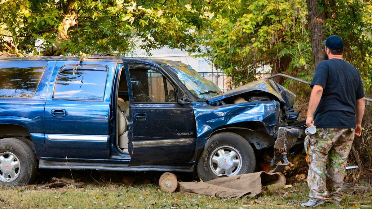Photos: Car crashes through fence, into yard