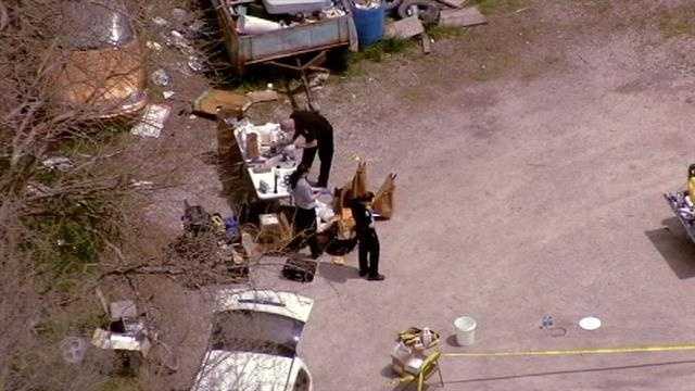 Investigators collect evidence at barn where 3 bodies found