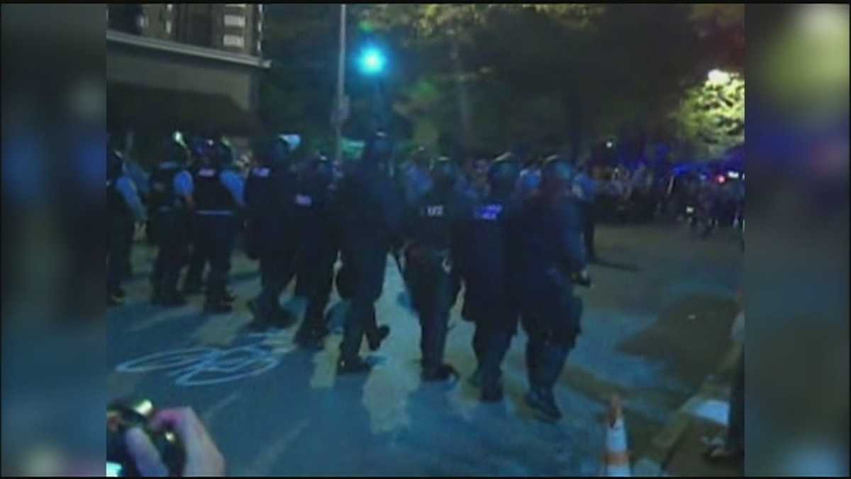 Angry protesters yell at riot police in St. Louis