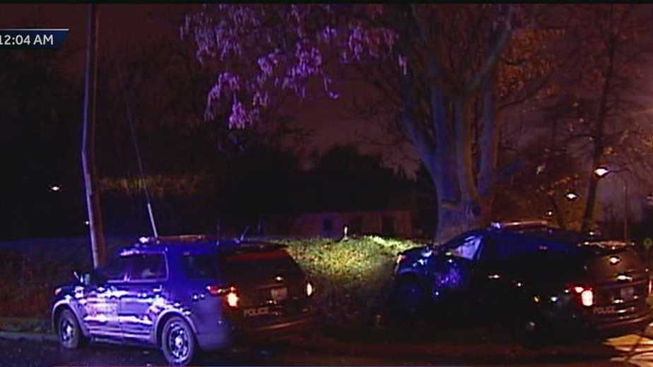 2 police cars skid off wet road during pursuit