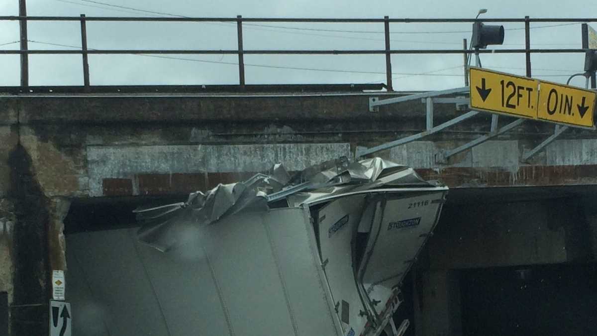 Truck stuck under railroad bridge on Independence Ave.