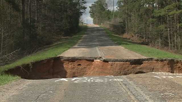 Road collapses under stress of flooding