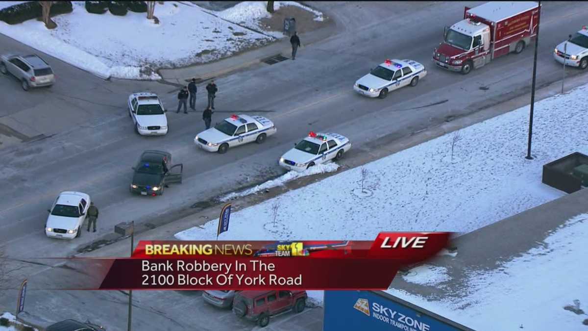 Armed bank robbery suspect struck by police car