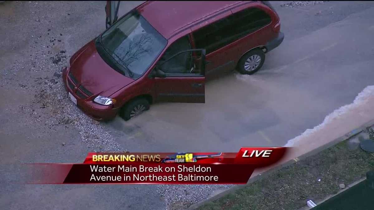Van stuck in street collapsed by water main break