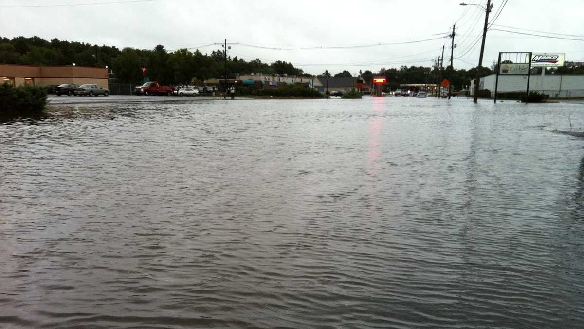 Torrential rains flood streets, close mall
