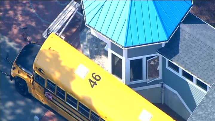 Photos: School bus rolls into building