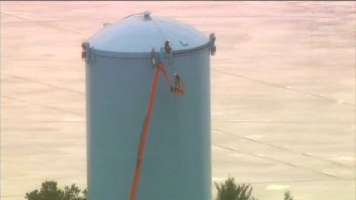 Frame-by-frame: workers rescued from water tower