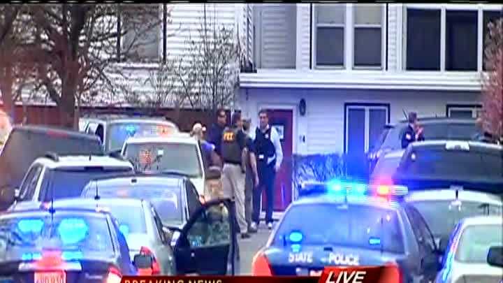 Photos: Police surround, capture suspect behind home