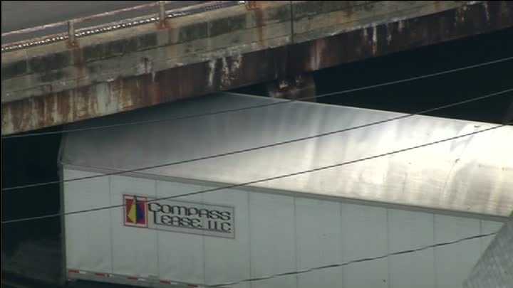 Photos: Truck stuck under highway bridge