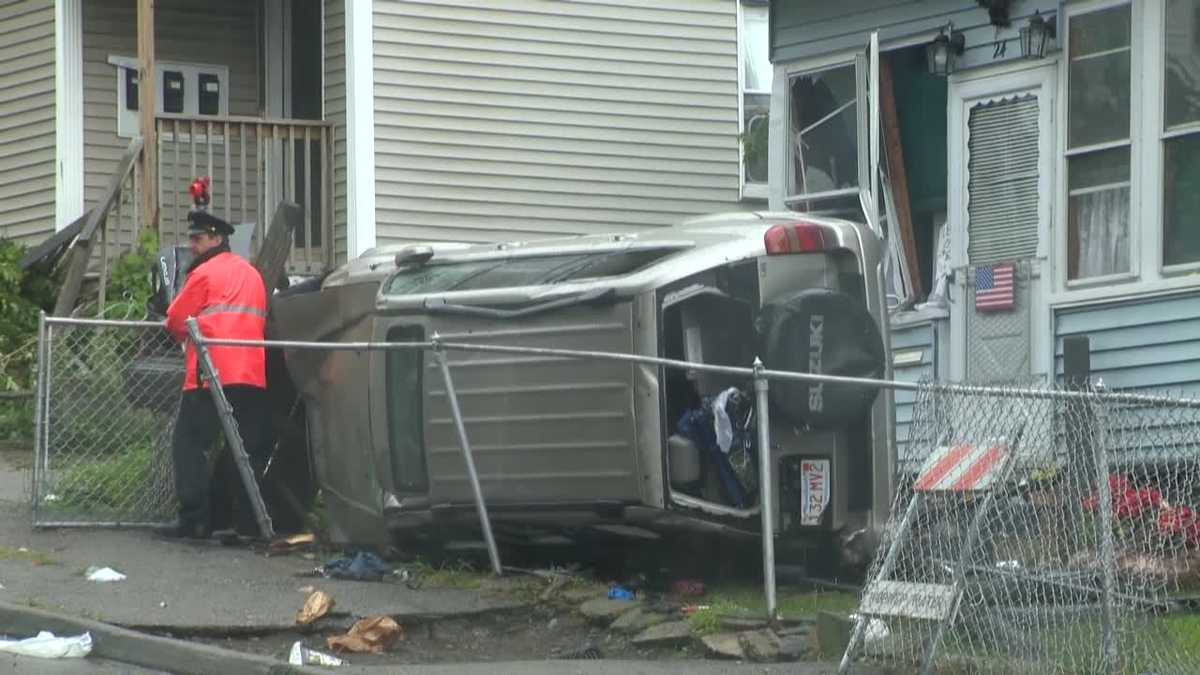 Photos: Van flips, lands in front yard of home