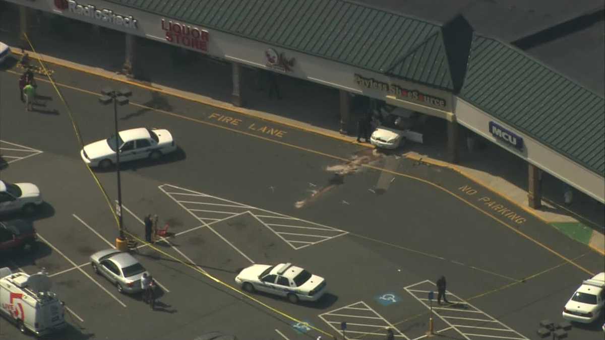 Images: Car crashes into shopping plaza