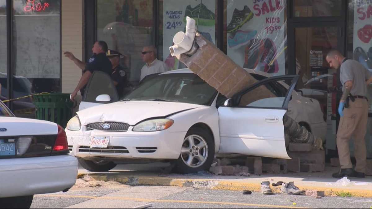 Officer injured when car crashes into store