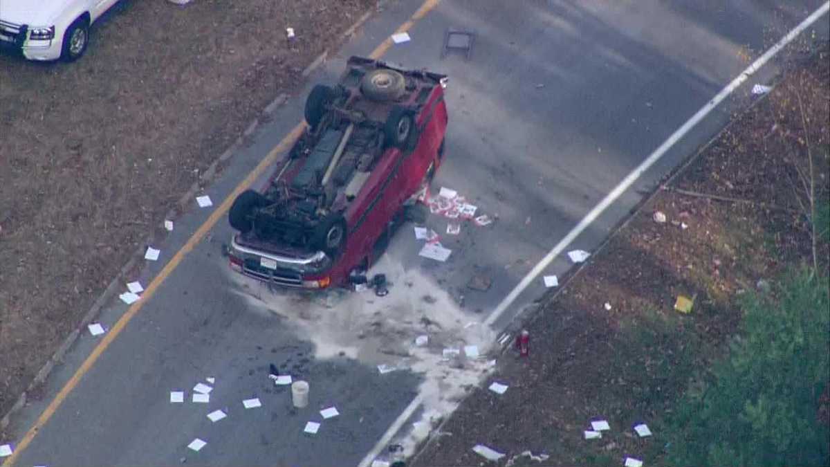 Truck flips over on highway exit ramp