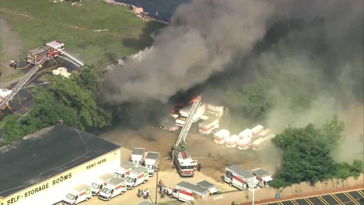Fire ravages building, spreads to U-Haul lot