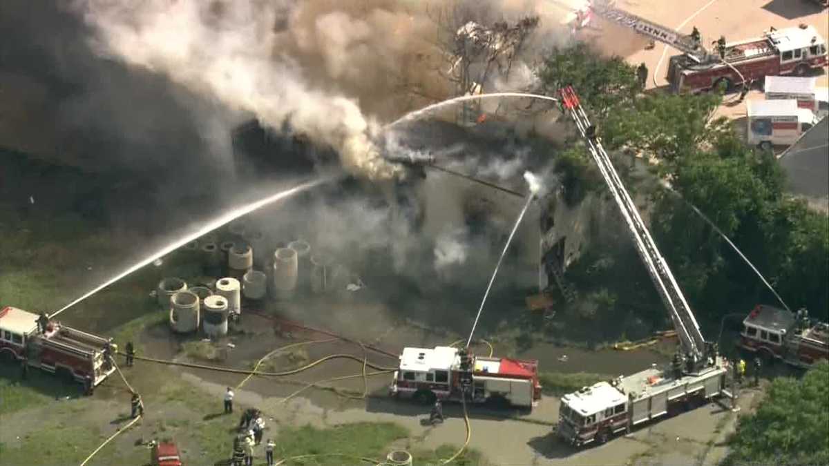 Fire ravages building, spreads to U-Haul lot