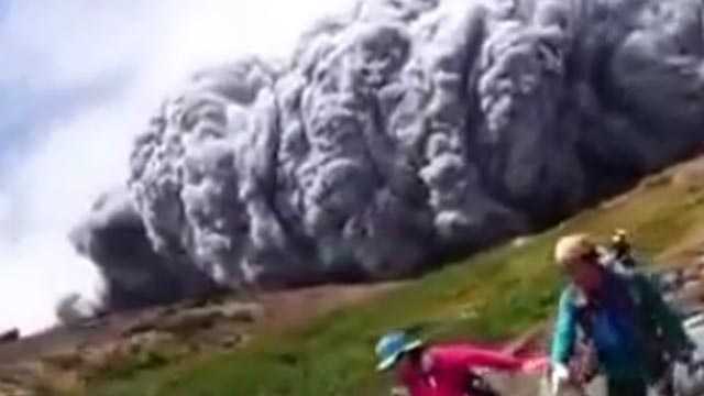Video shows ash cloud from erupting volcano overtake hikers
