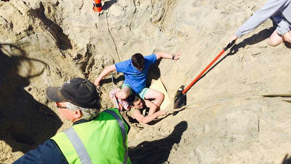 Firefighters, police help rescue person buried in sand