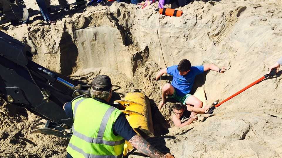 Firefighters, police help rescue person buried in sand
