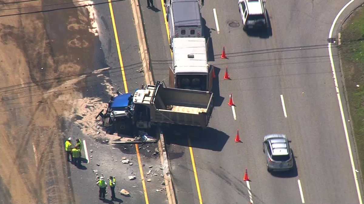 Dump truck crashes into highway median