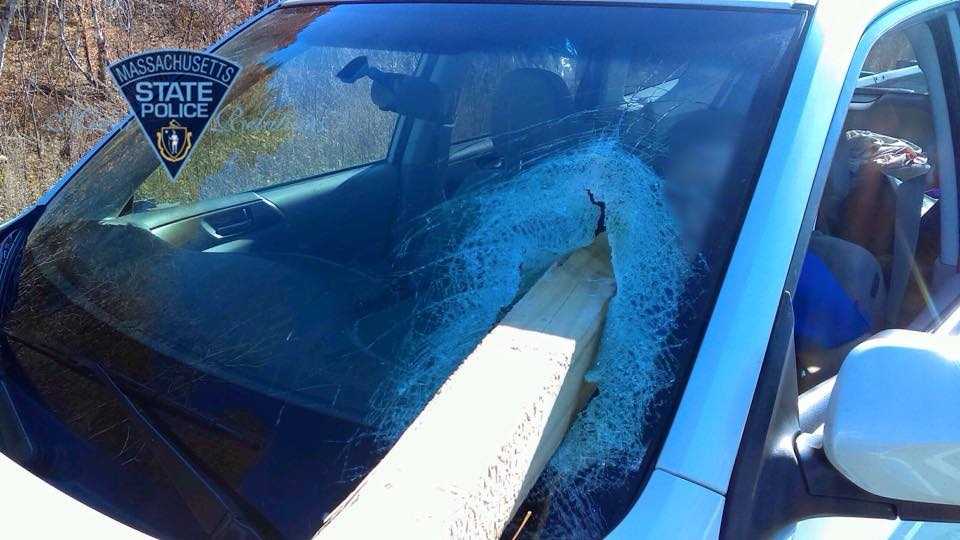 Woman survives large wood post through windshield
