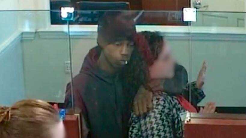 Armed bank robber held teller in stranglehold