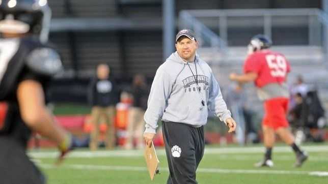 College football coach placed on leave, accused of domestic violence