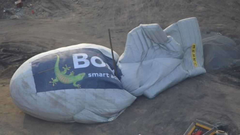 Deflating blimp crashes to ground in neighborhood