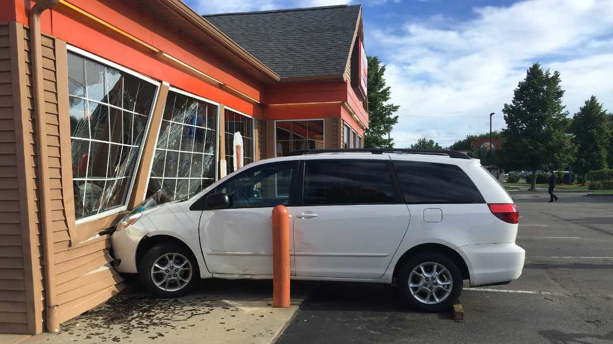 Surveillance video records minivan crashing into Dunkin' Donuts