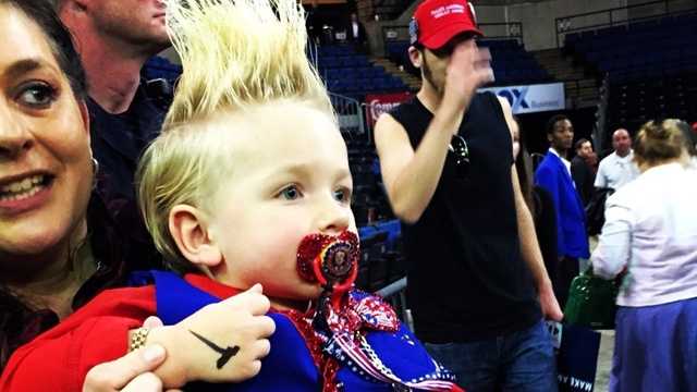 Trump autographs baby at rally