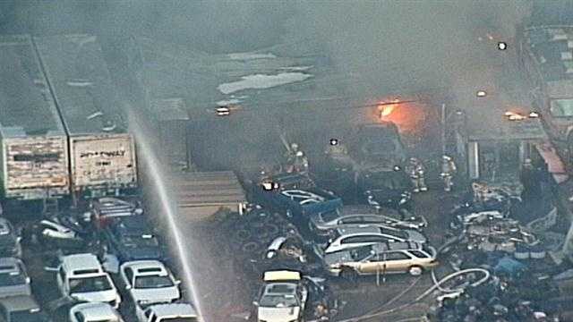 Large plume of smoke rises from junk yard fire