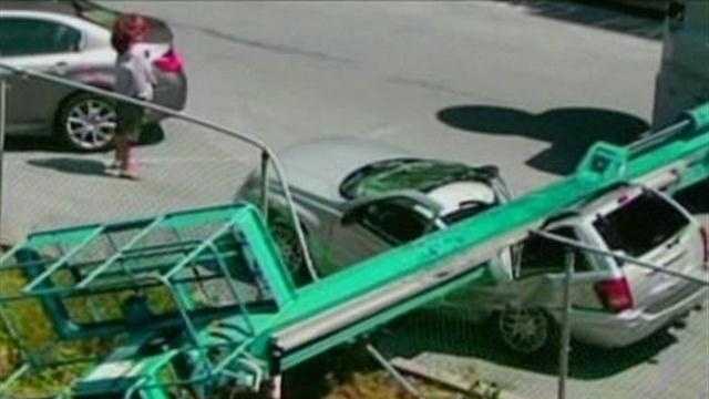 Boom lift falls on top of SUV