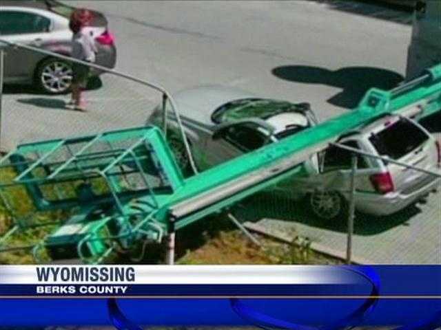 Boom lift falls on top of SUV