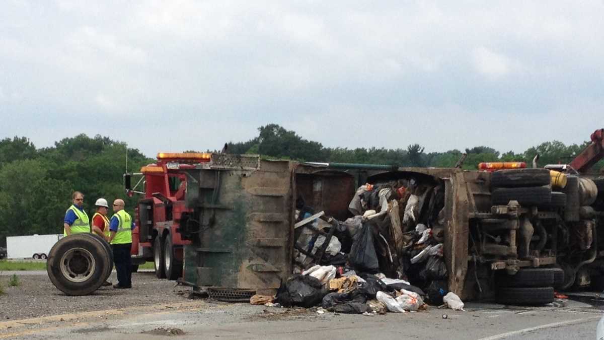 Photos: Garbage truck flips onto side, shuts down interstate ramp