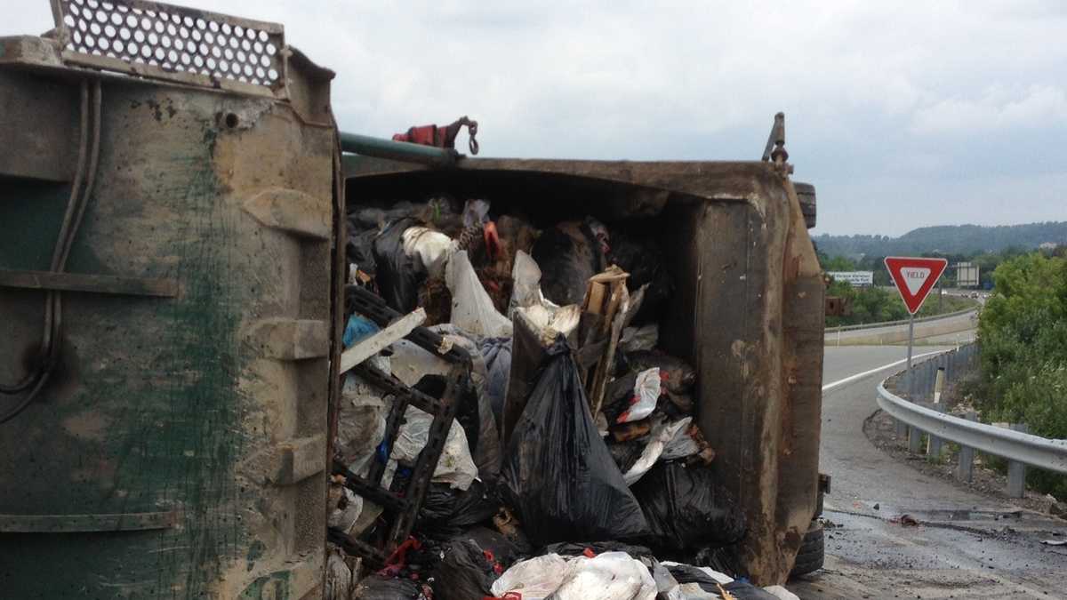 Photos: Garbage truck flips onto side, shuts down interstate ramp