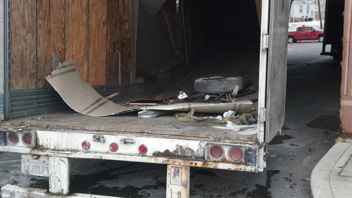 Photos: Tractor-trailer becomes wedged under bridge