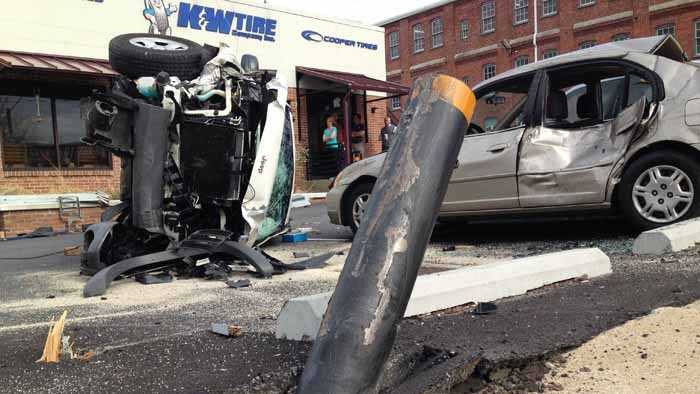 Vehicle hits two utility poles, car