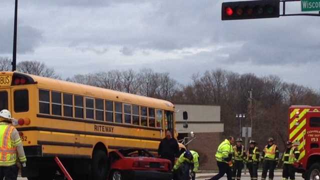 Car gets wedged under school bus in Grafton