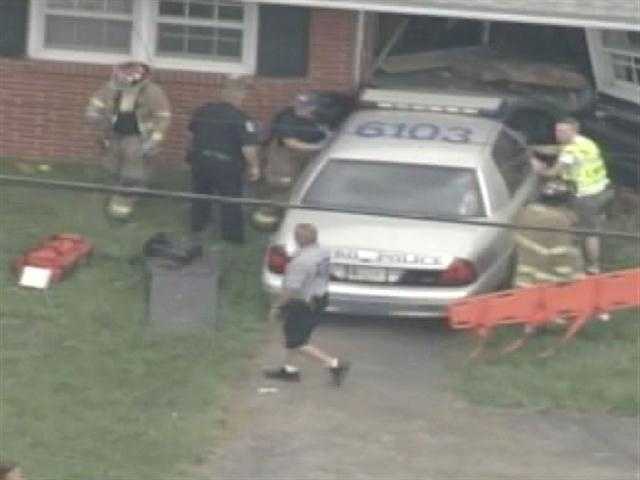 Images: Police car crashes into house