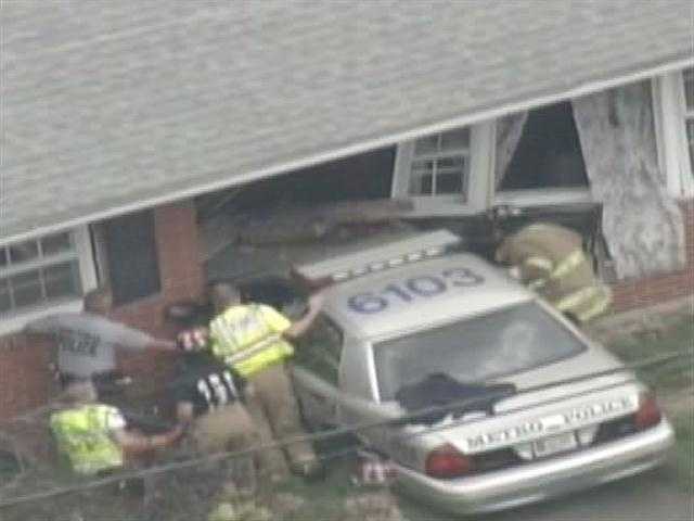Images: Police car crashes into house