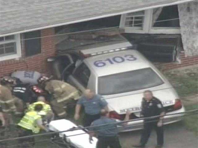 Images: Police car crashes into house