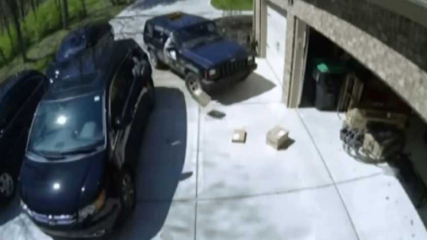 Investigation underway after video shows postal carrier throwing packages