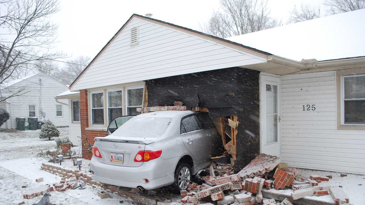 Driver, passenger unhurt when car hits house