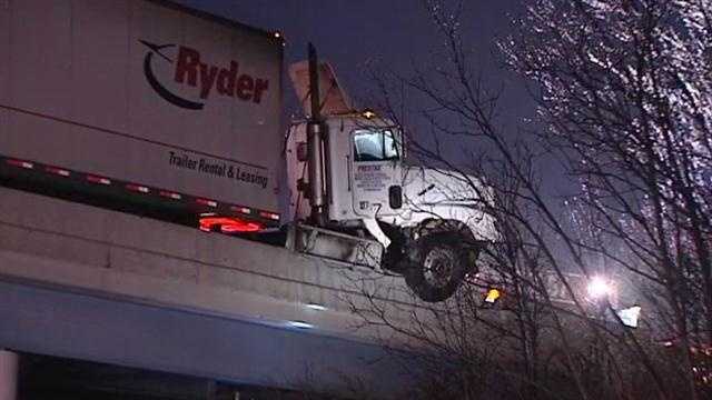 Photos: Truck crashes through bridge barrier