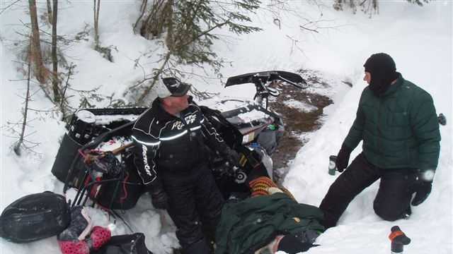 Man survives nearly 20 hours trapped under snowmobile