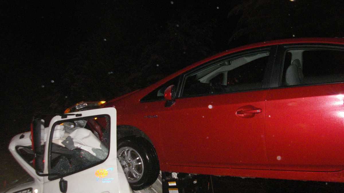 Car drives up ramp, crashes on top of tow truck in Sutton