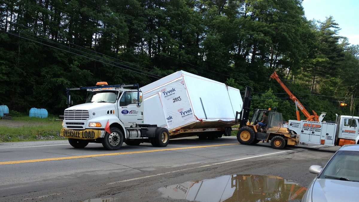 Photos: Trailer hauling modular home tips over